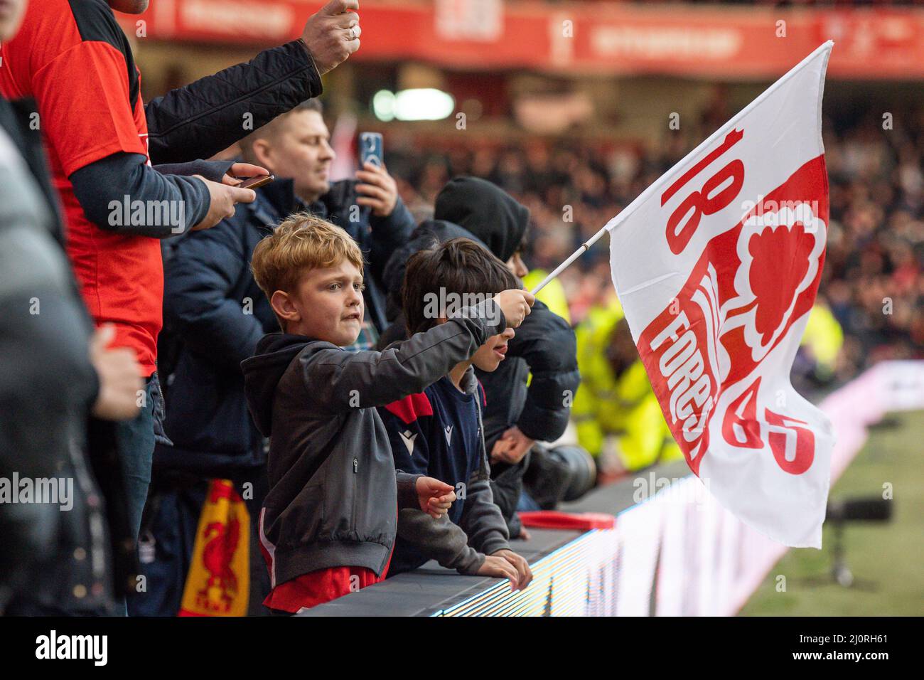 a young Nottingham Forest fan waves his fan before the teams come out ...