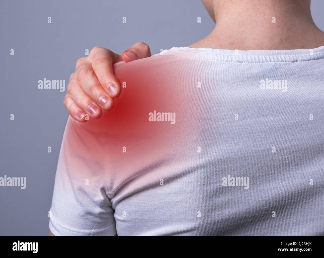 Woman suffering from shoulder pain. Trigger point. Hand holding ...