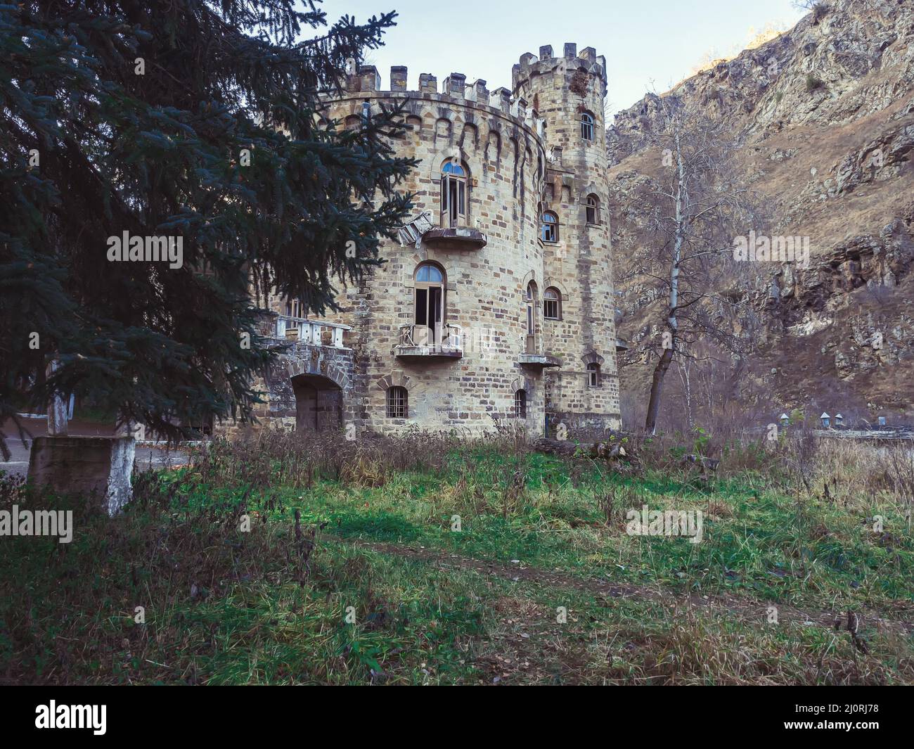 Old abandoned castle with ruined balconies and broken windows in wooded ...
