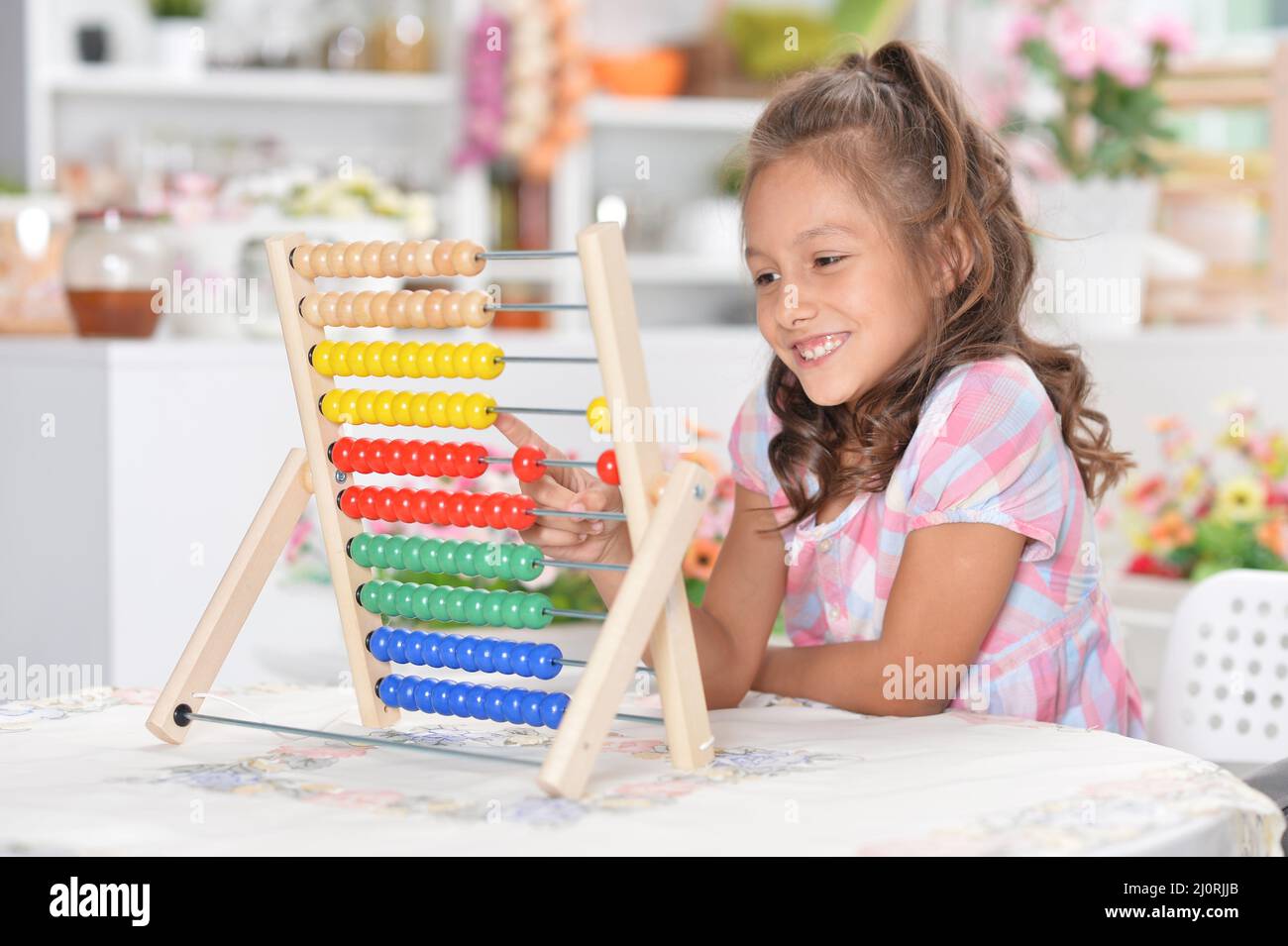 Cute little girl learning to use abacus Stock Photo - Alamy
