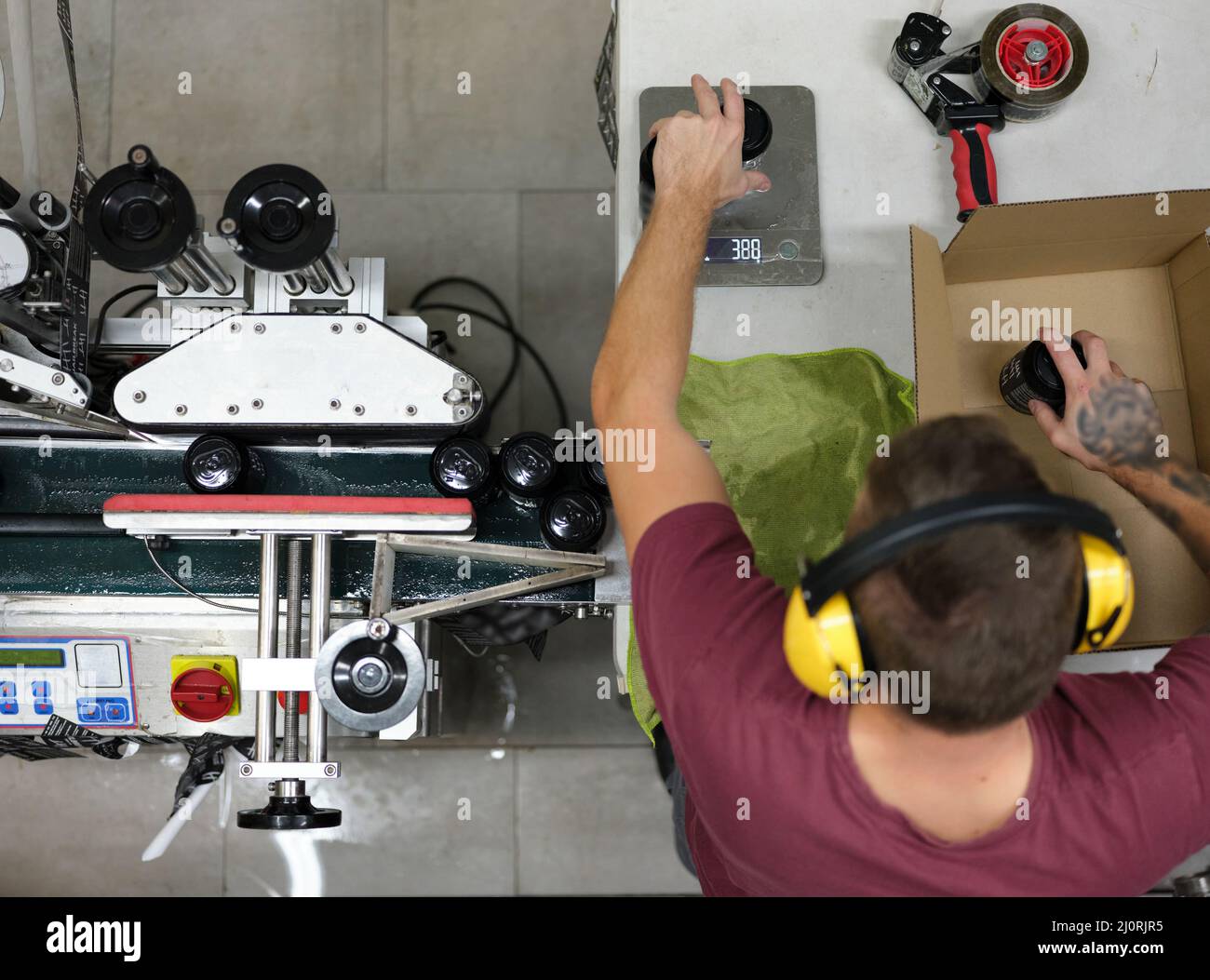 Top view of a worker packing cans of beer for a deliver in a craft beer ...