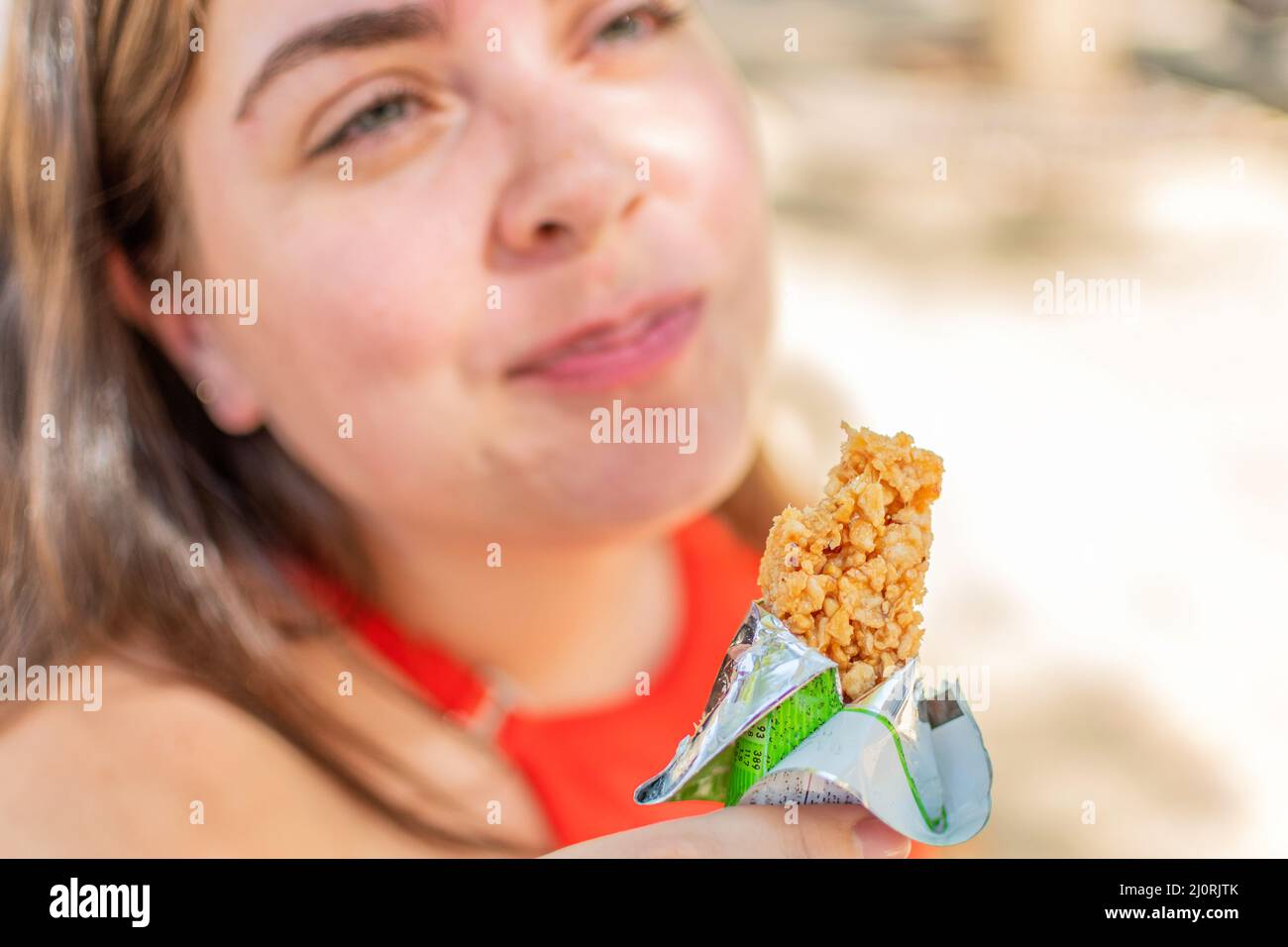 Girl eating cereal bar hi-res stock photography and images - Alamy