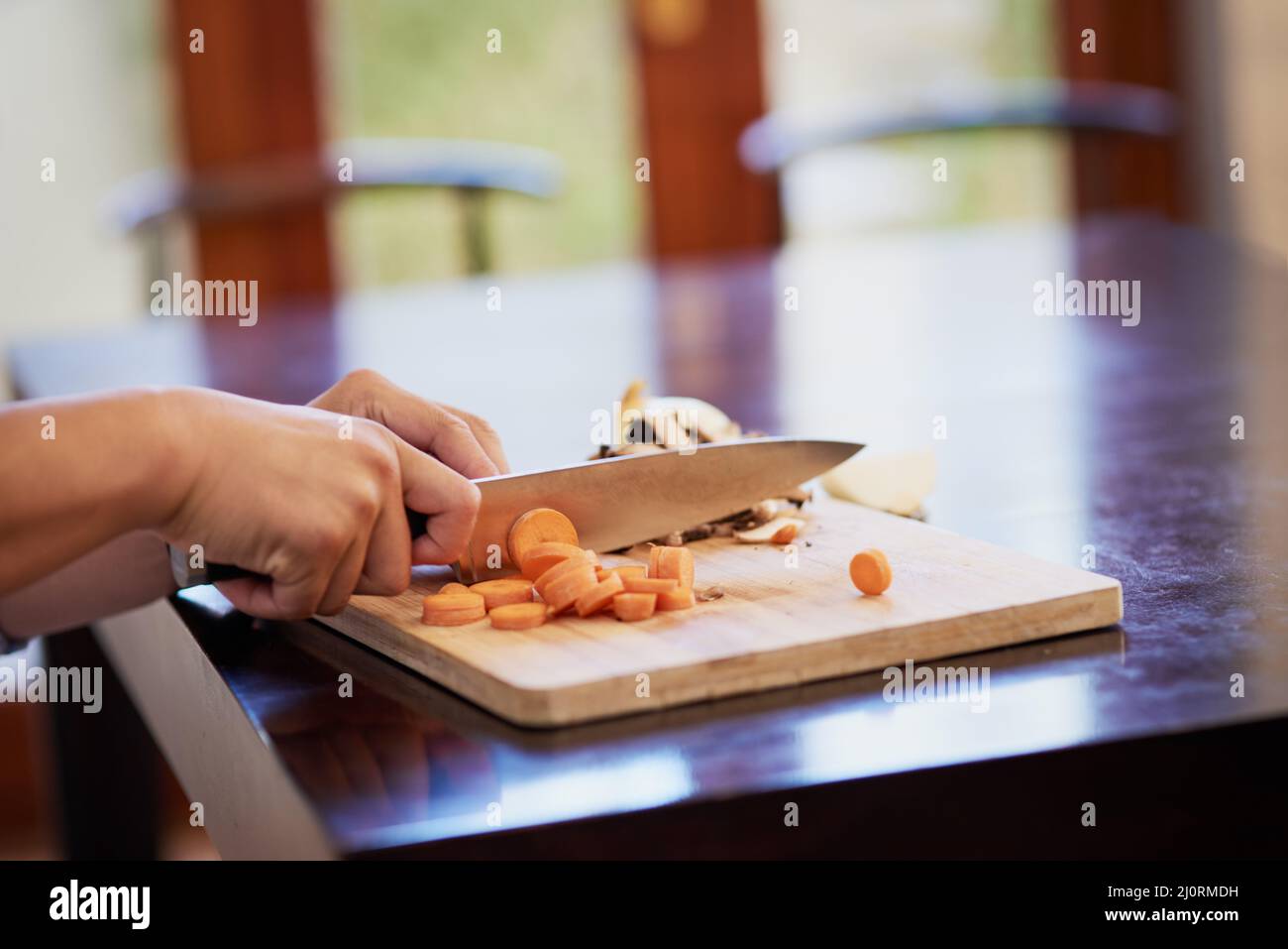Dinner time. Closeup shot of an unrecognizable woman chopping carrots ...