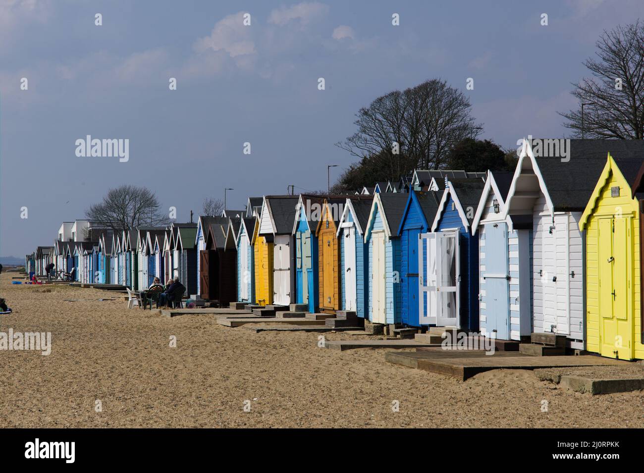 View of pictureesque beach huts West Mersea beach, Essex, Britain on a ...