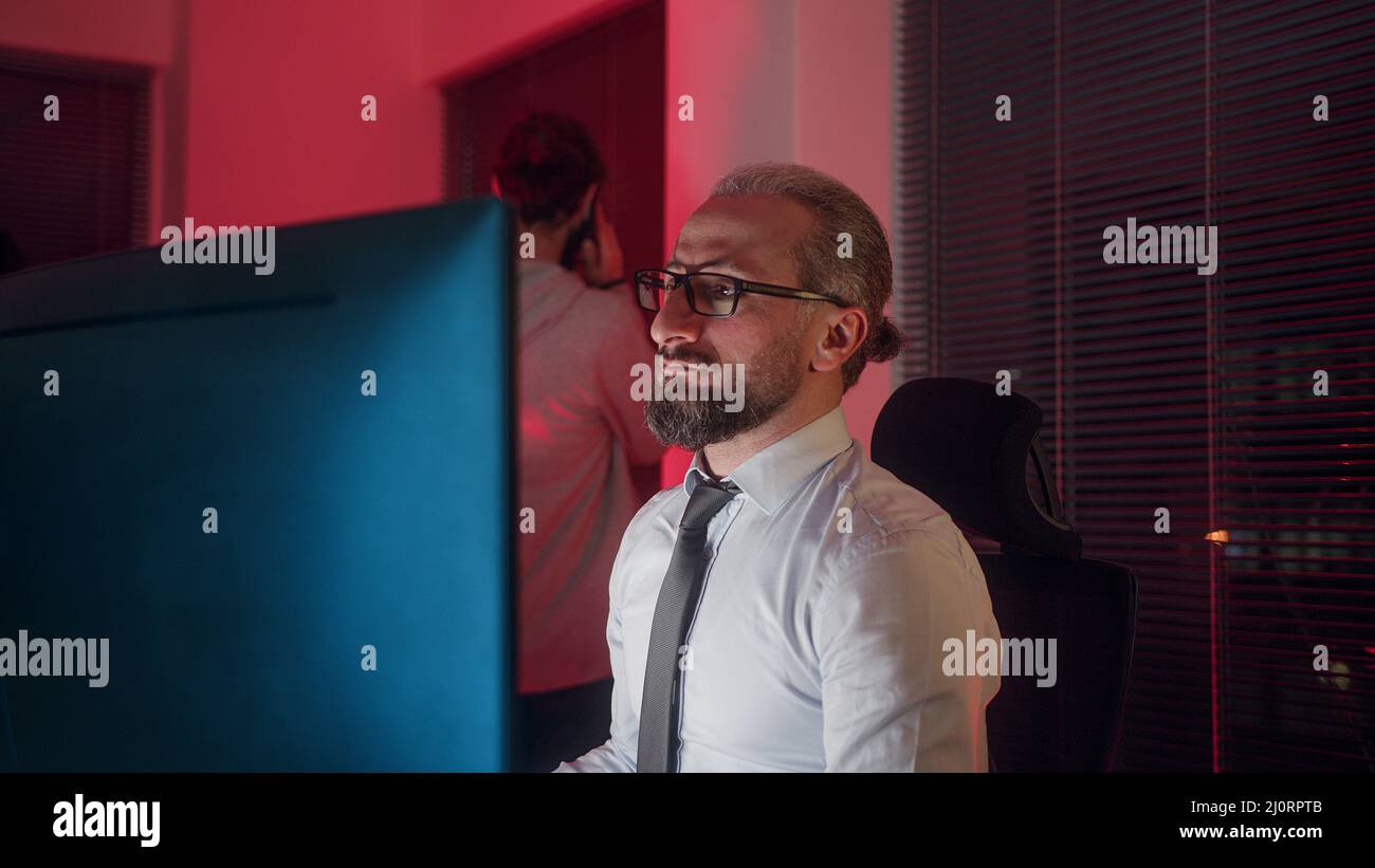 Middle-aged company CEO or boss is training his trainee, trying to help ...