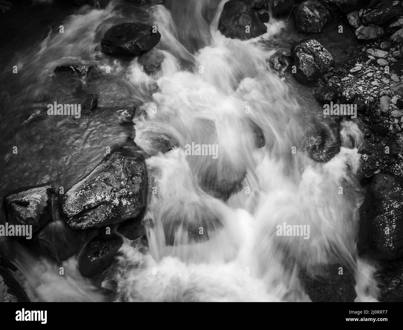 Closeup of the river stream with the rocks and stones in the water ...