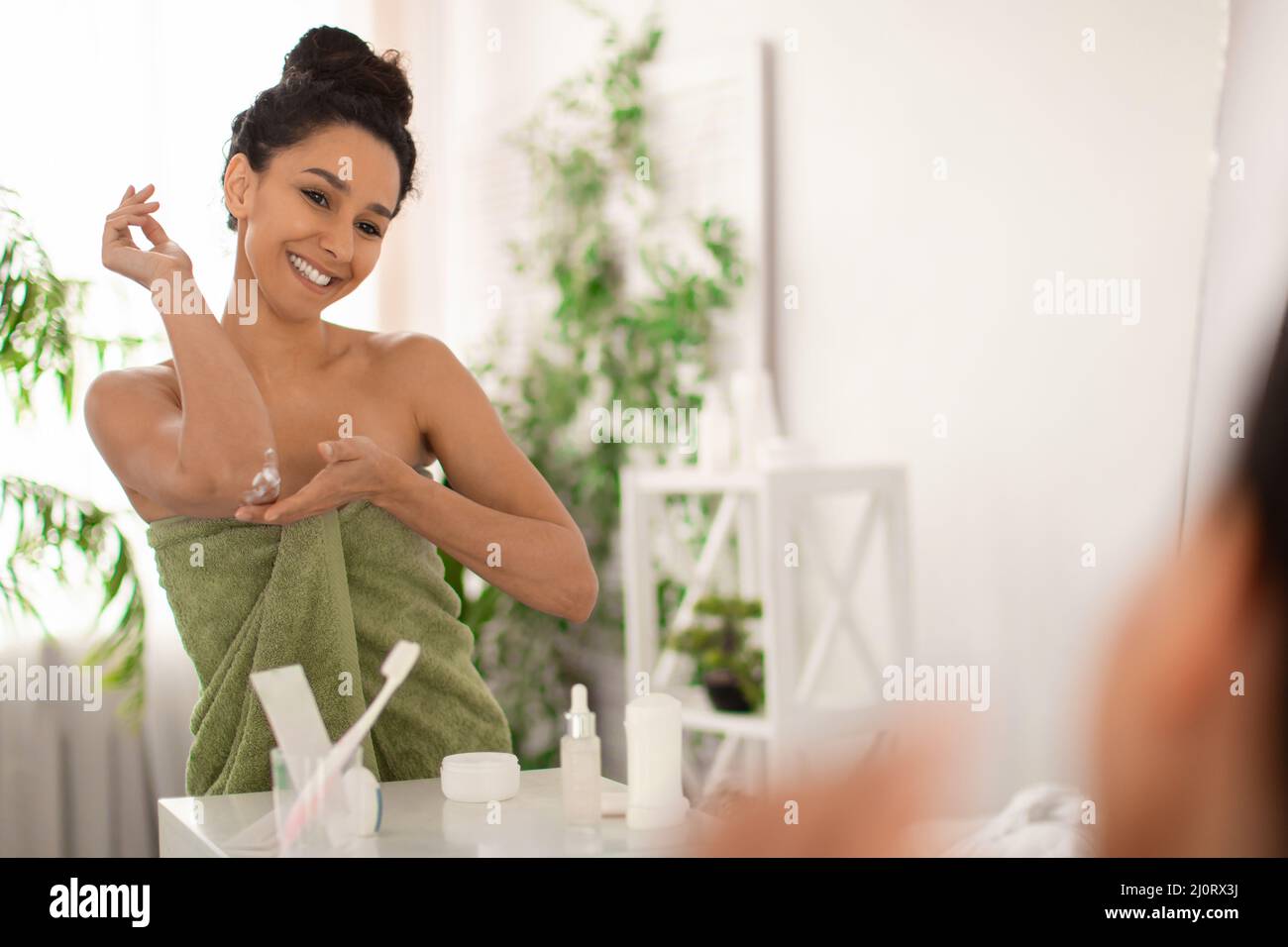 Woman applying lotion elbow in hi-res stock photography and images - Alamy