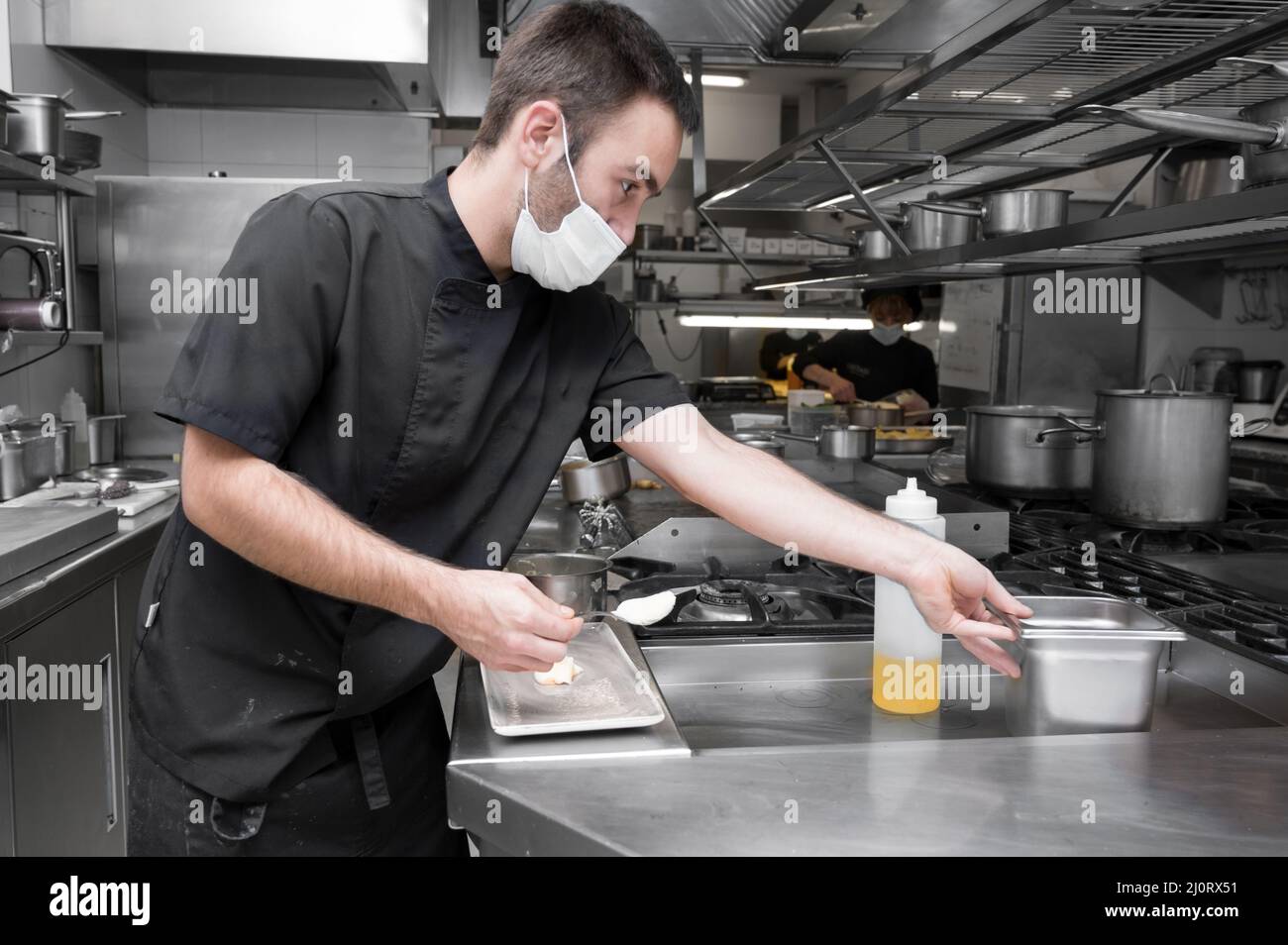 Chef cooking in modern industrial kitchen Stock Photo - Alamy