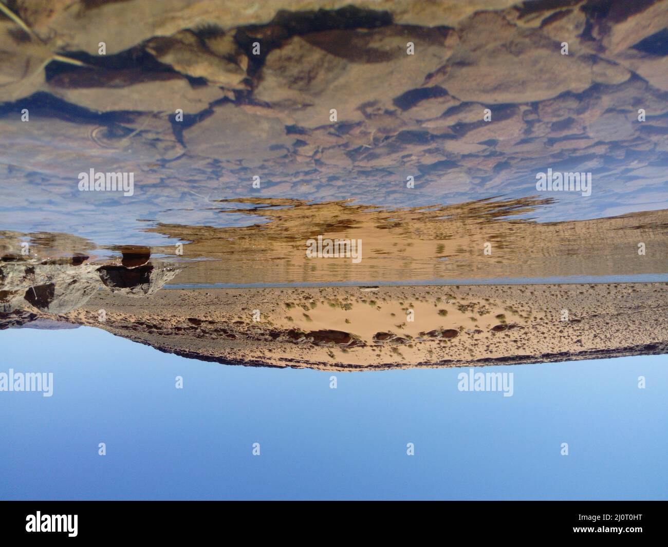 Scenic view of the sandy hill with reflection in the water under the ...