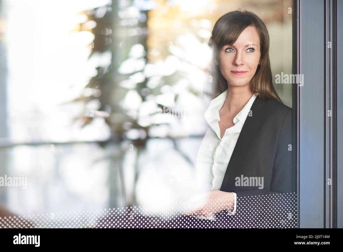 Businesswoman in corporate workplace taking break and drinking coffee ...