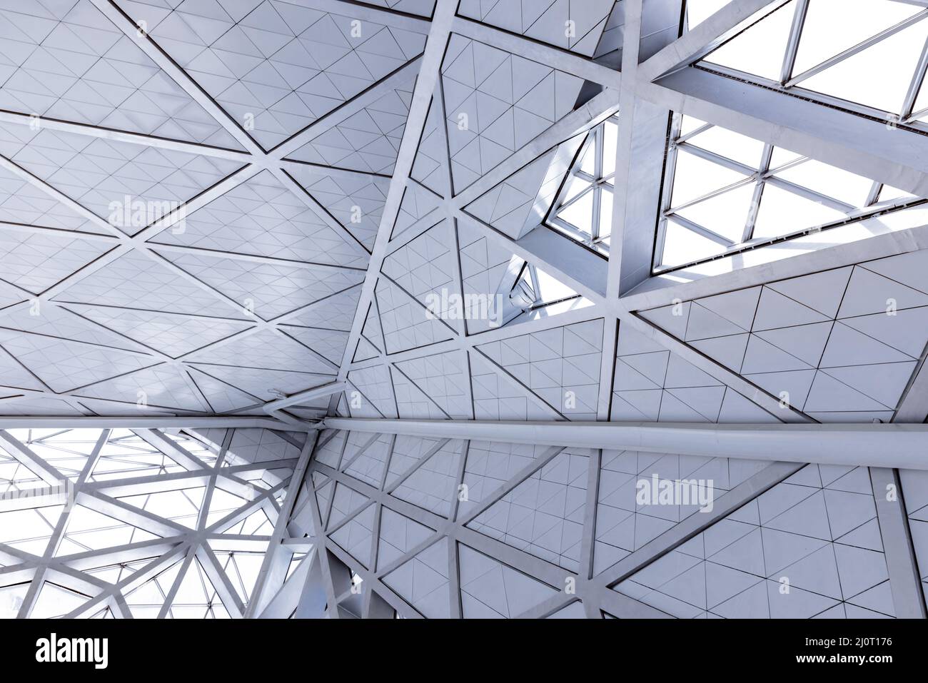 Low-angle shot of a modern white building ceiling and triangle roof ...