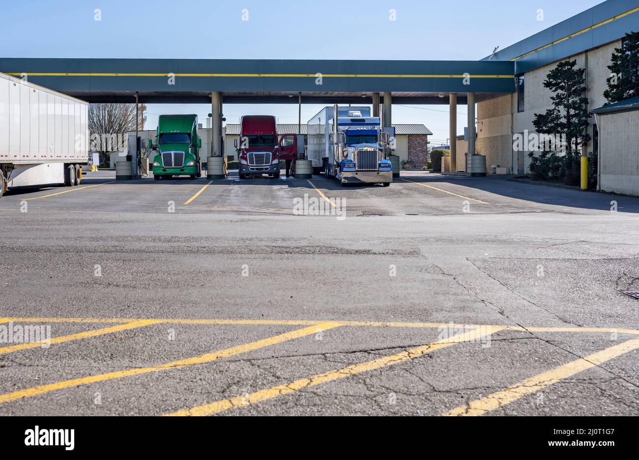 Industrial big rigs semi trucks and semi trailers standing on the truck ...