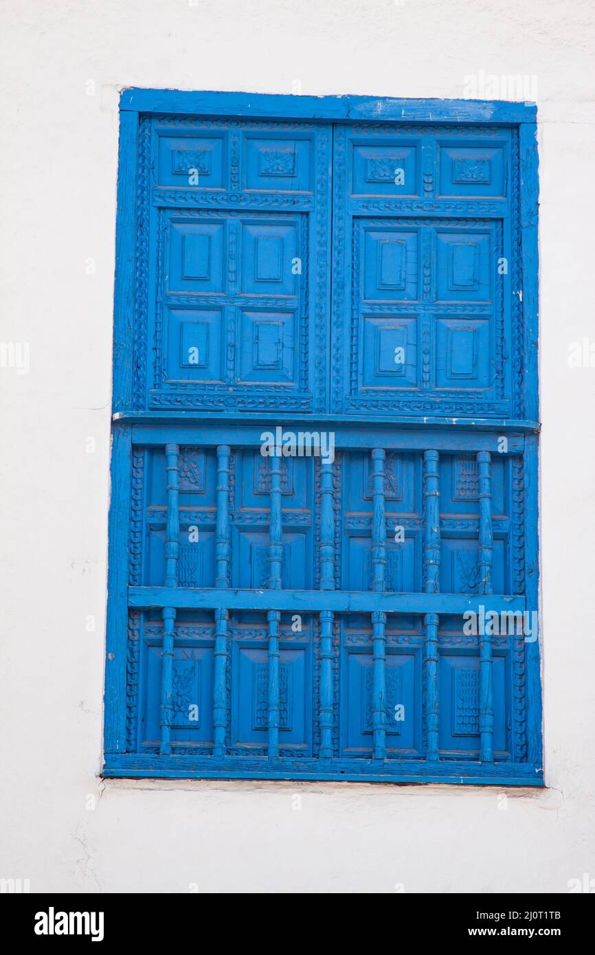 Closeup of a blue wood window in a typical facade of a building in ...
