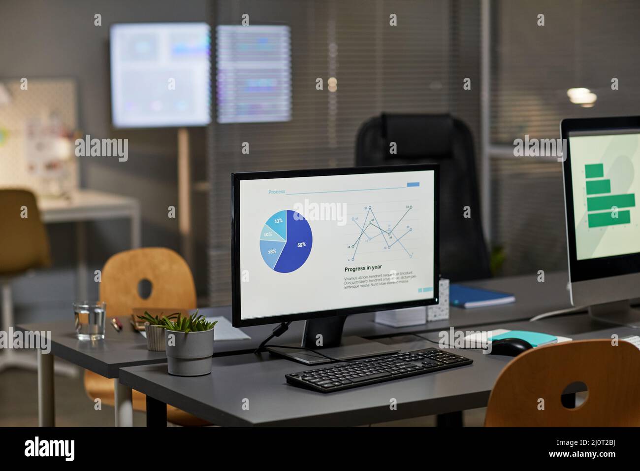 Background image of computer monitor in office with marketing charts ...