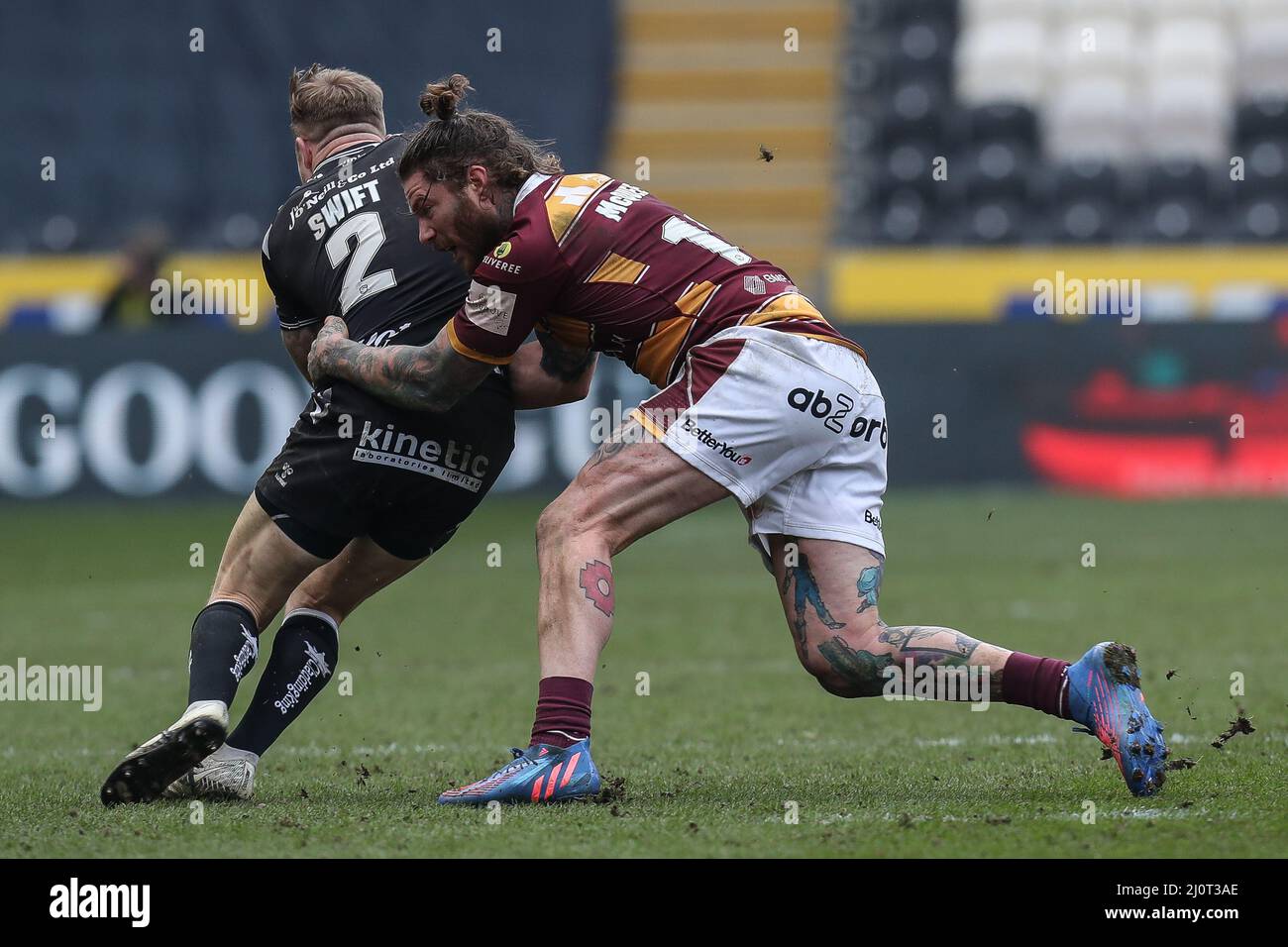 Adam Swift #2 of Hull FC is tackled by Chris McQueen (12) of ...