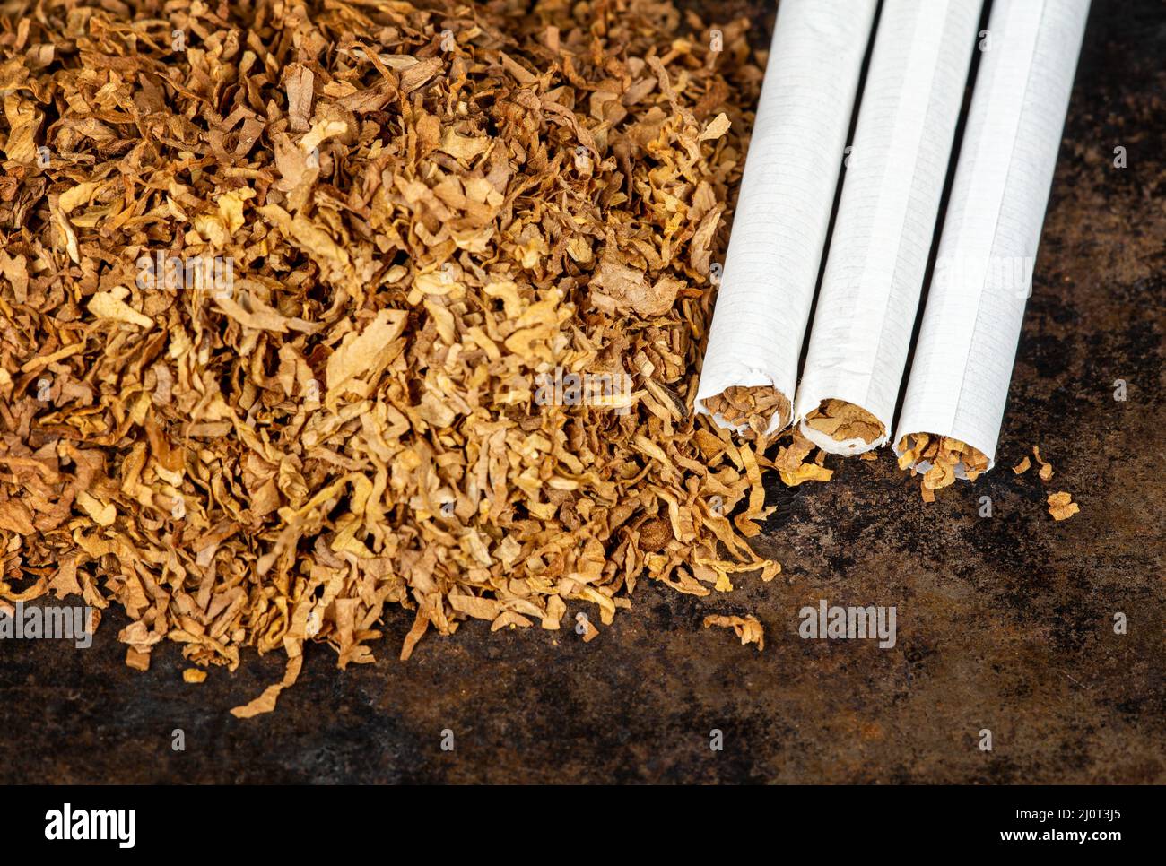 Rolled cigarettes on tobacco, smoking background with copy space Stock ...