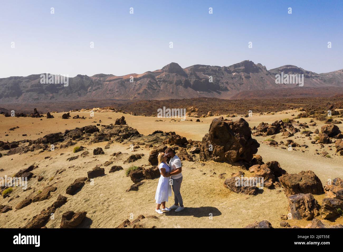 People in love kiss in the crater of the Teide volcano. Desert ...