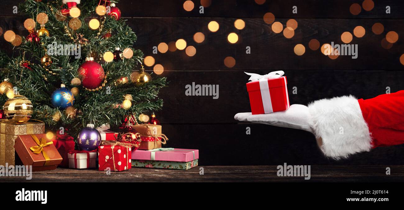 Santa holding present hi-res stock photography and images - Alamy