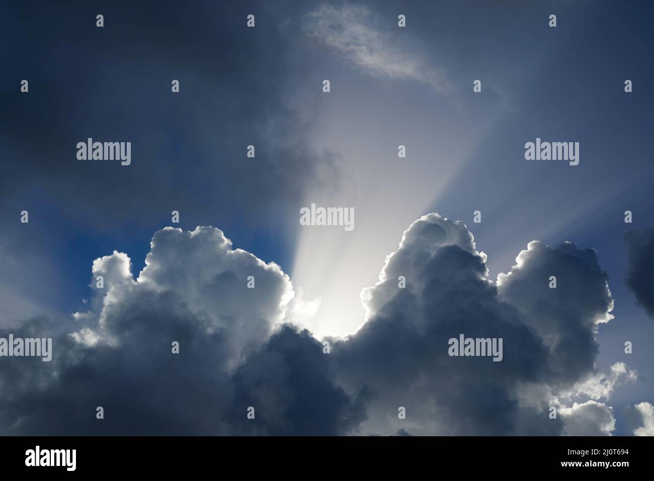 Rays of sunshine through clouds Stock Photo - Alamy