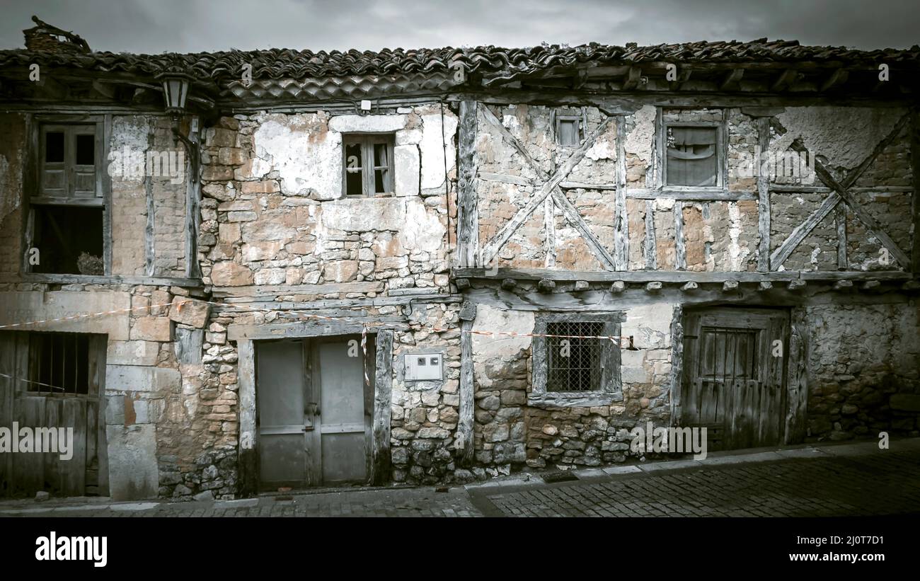 Facade of a brick house in a village in very poor condition. Several ...