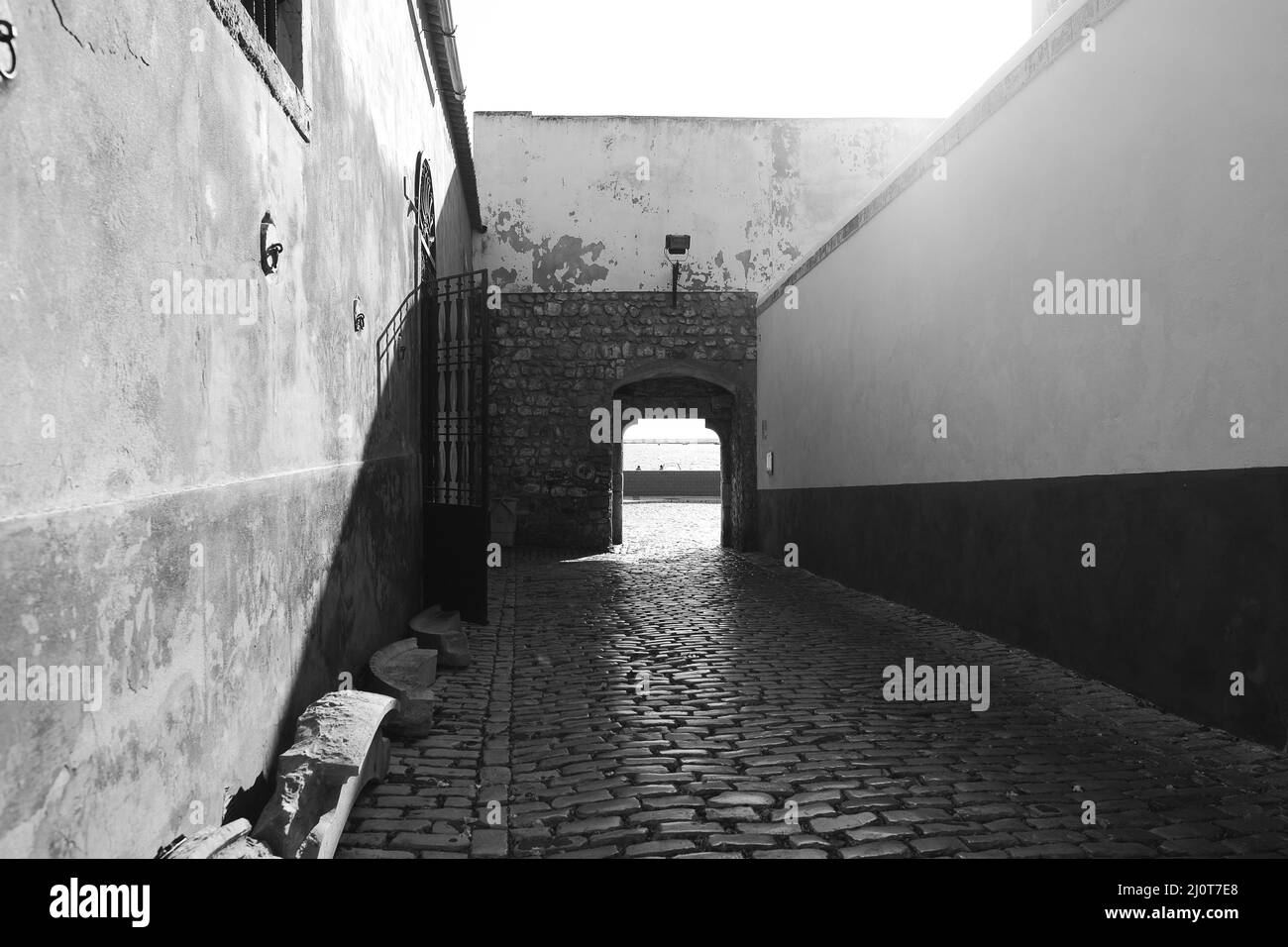 View of the narrow brick street in grayscale in Portugal, Lisbon Stock ...