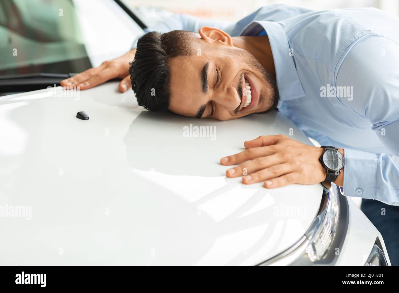 Happy young arab man hugging car of his dream Stock Photo - Alamy