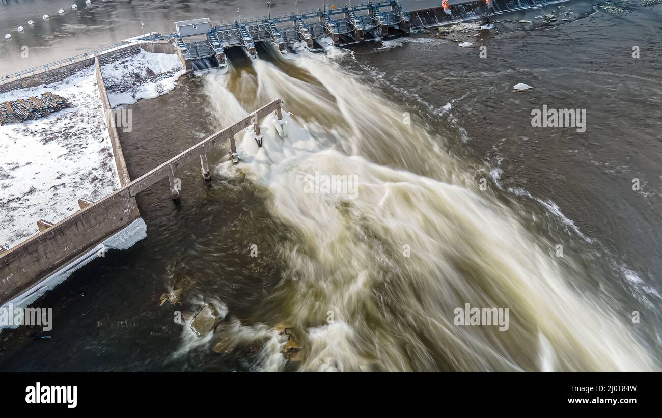 Water is rushing at the dam in winter as spring approaches with ...