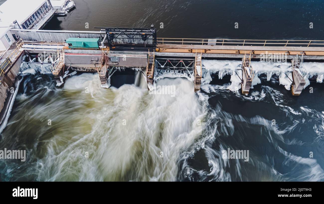 Water is rushing at the dam in winter as spring approaches with ...
