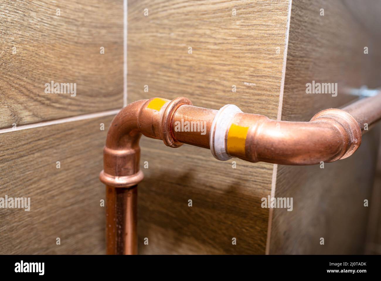 Copper pipe elbow for for natural gas installations, attached to a wall ...