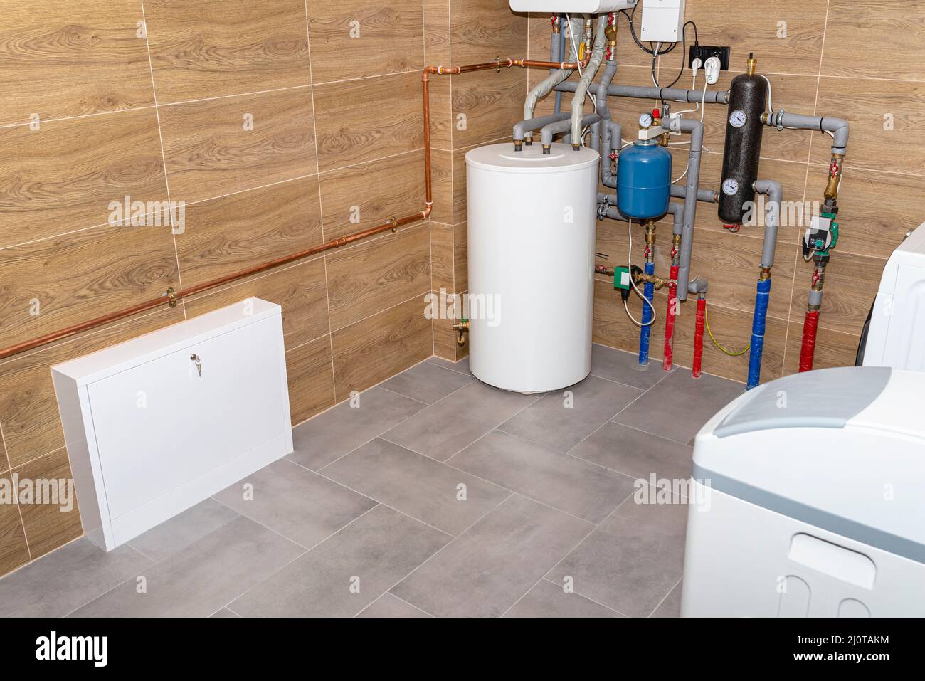 A modern gas boiler for natural gas, installed in a boiler room lined ...