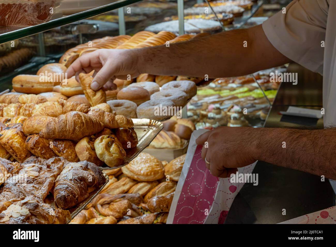 Artisan baker and pastry chef. Chef baker serving pastries in a bakery ...