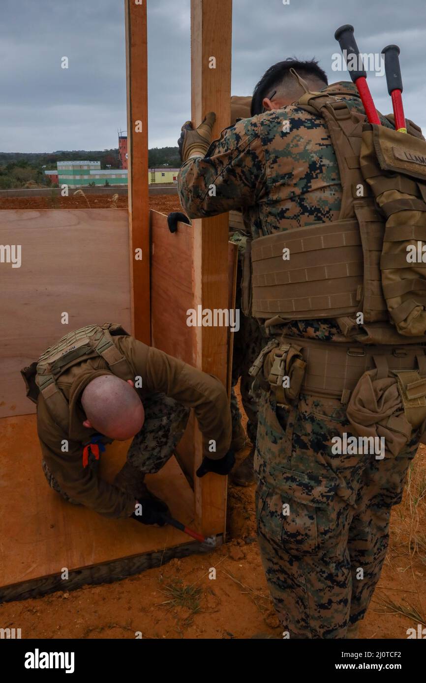 U.S. Navy Petty Officer 2nd Class Jonathon Riley, a builder with Naval ...