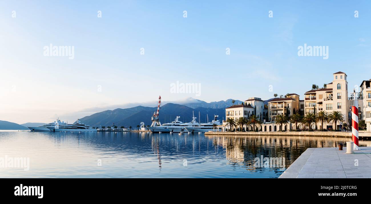 Modern buildings against the backdrop of mountains and a marina. Porto ...