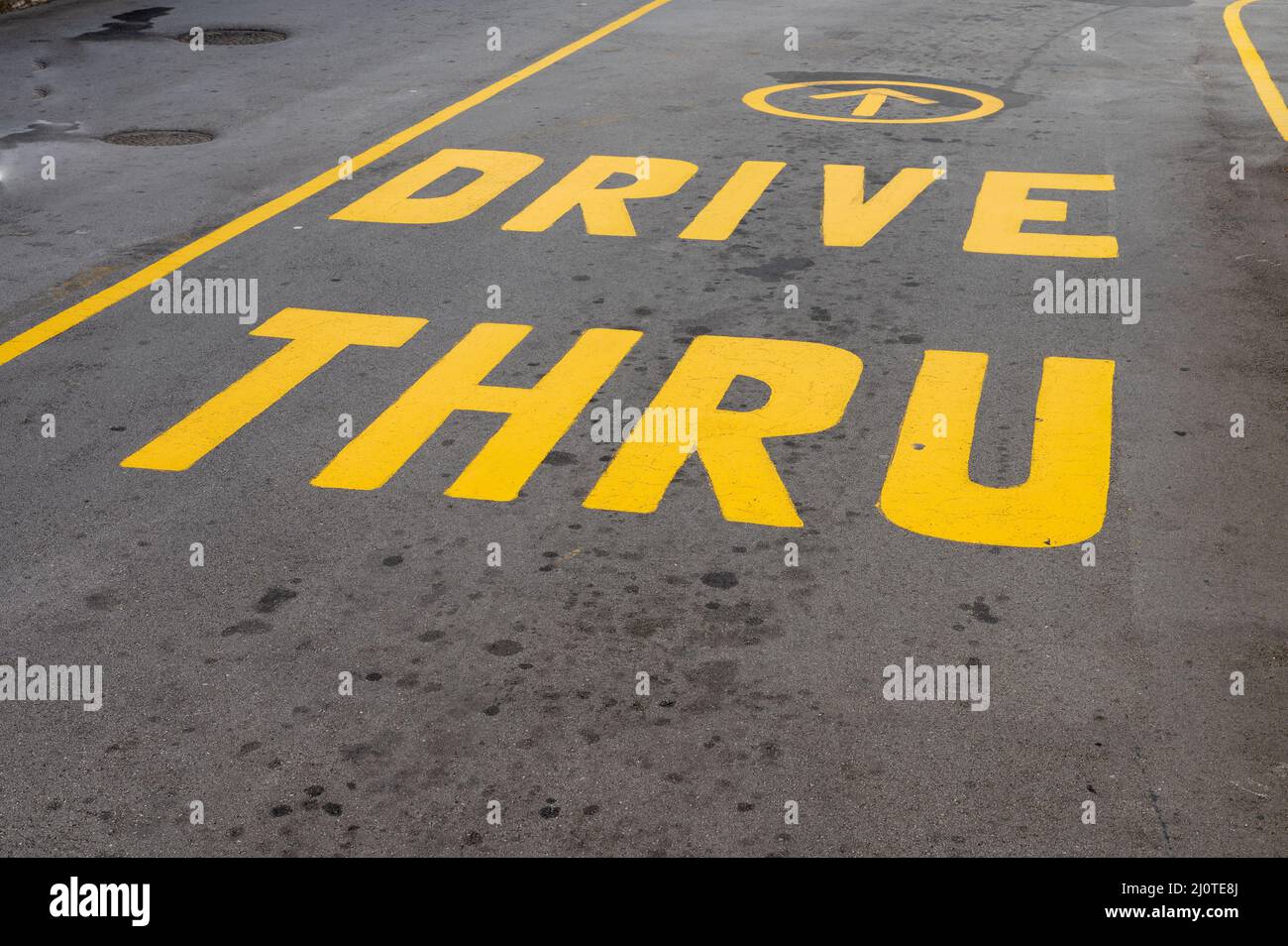 Drive thru sign on tarmac Stock Photo - Alamy