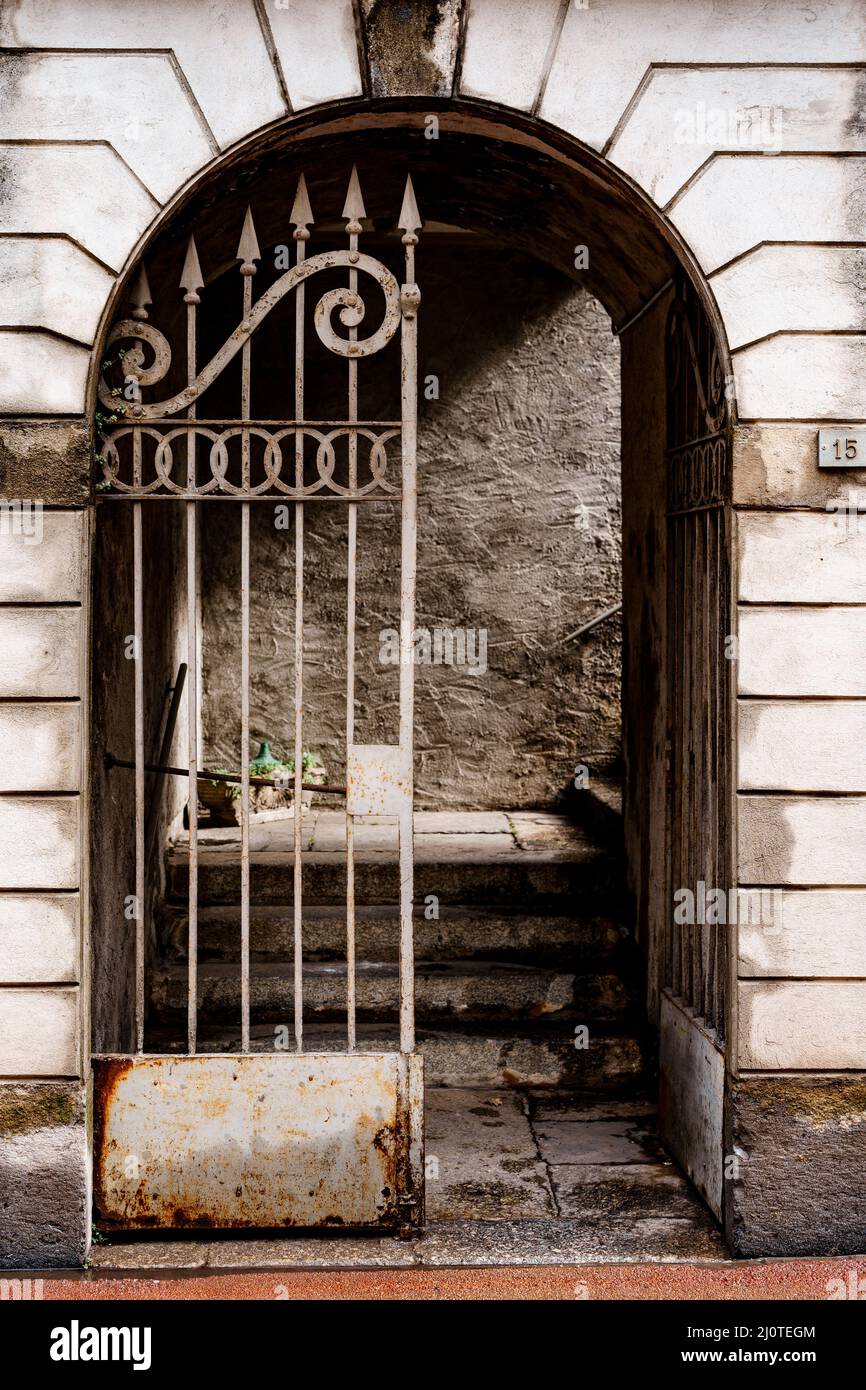 Wrought-iron gate with sharp prongs in the arched entrance to the ...