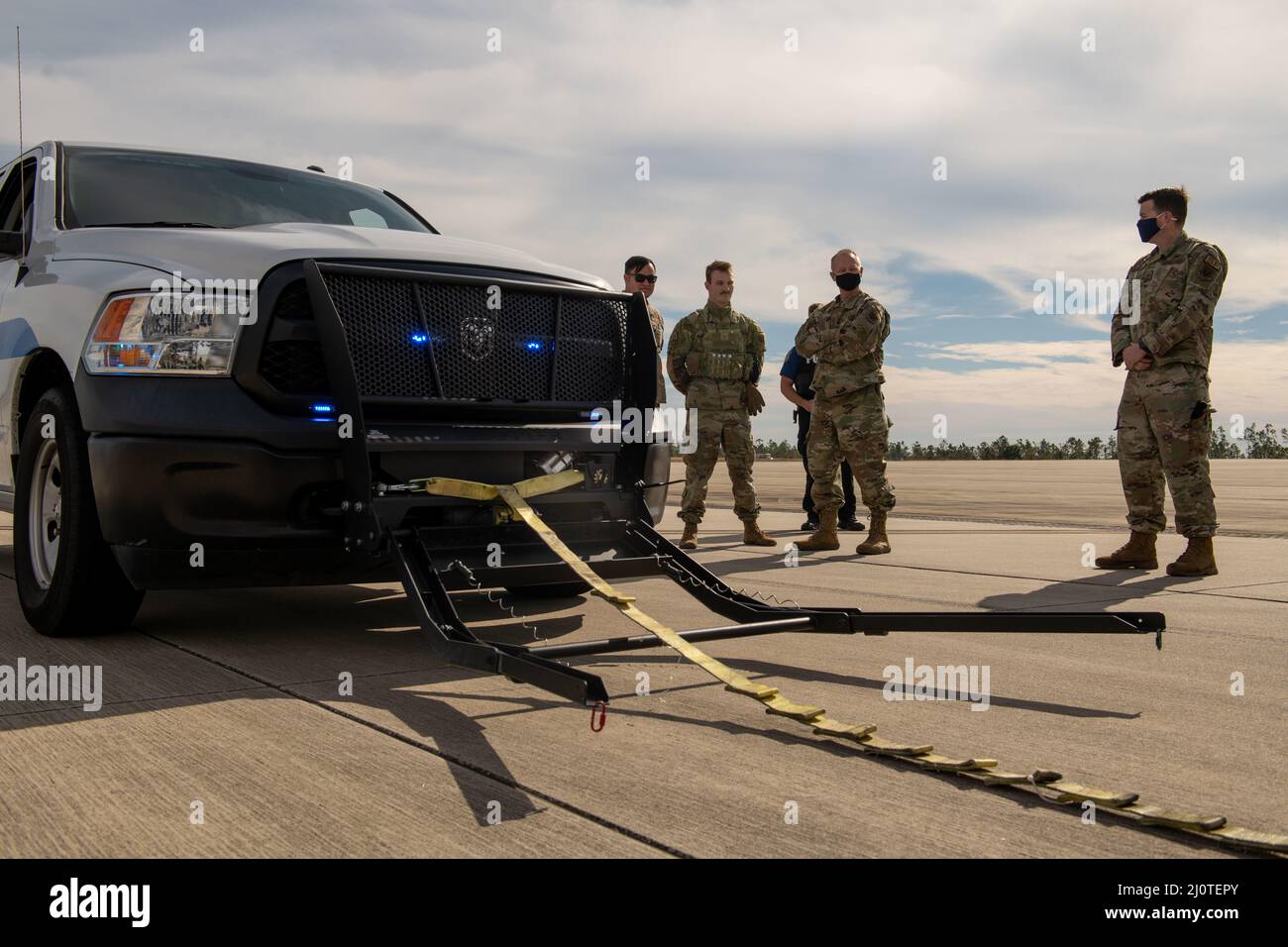 Members of the 325th Security Forces Squadron discuss the use of a ...