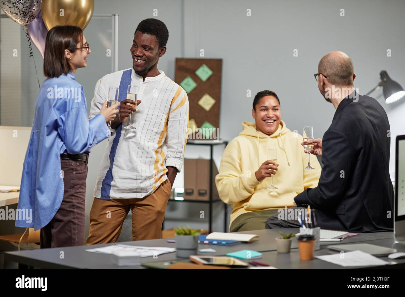 Diverse group of business people chatting while relaxing together at ...