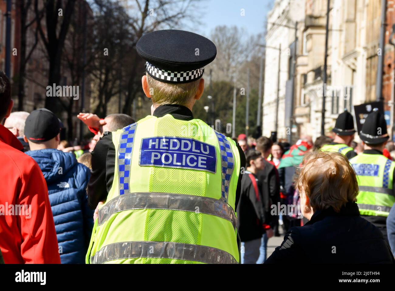 Cardiff, Wales - March 2022: Rear view of a police officer on duty in a ...