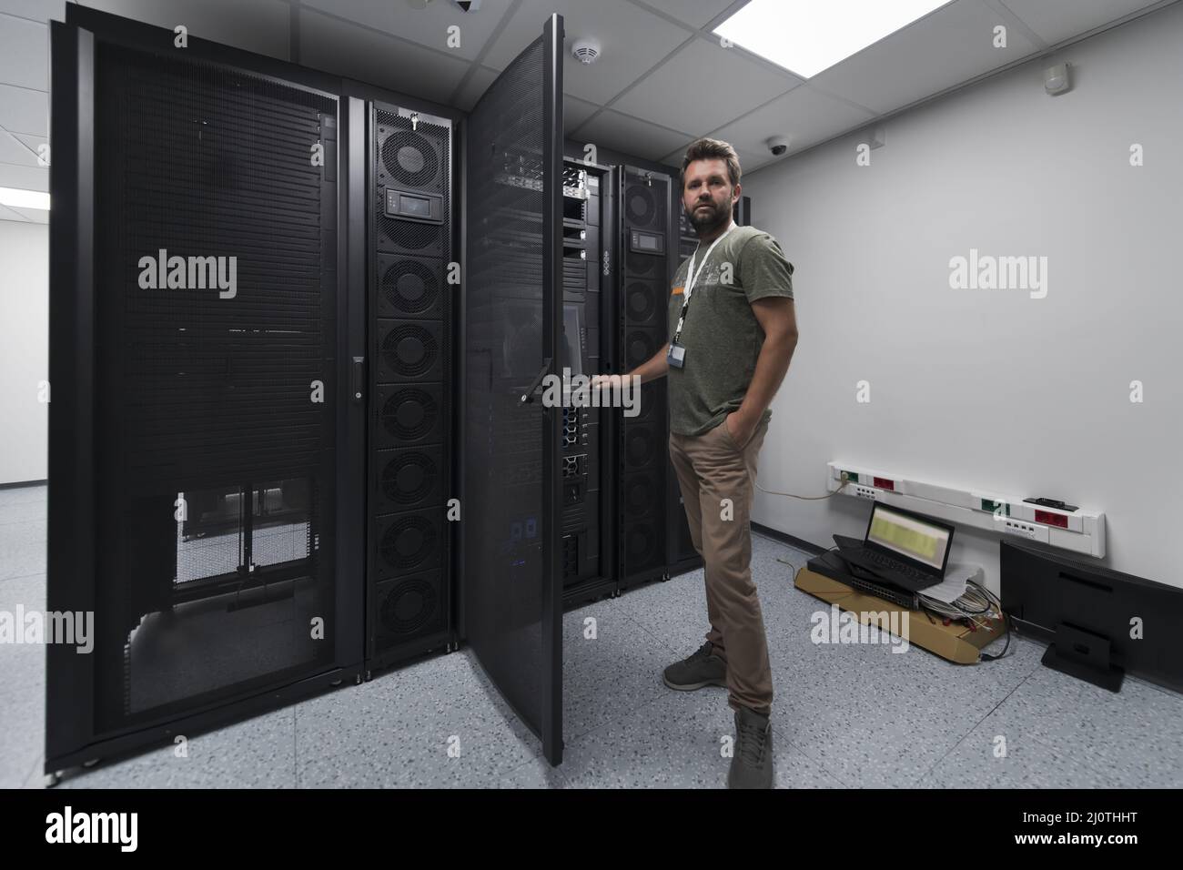 Data Center Engineer Usaing Keyboard on a Supercomputer Server Room ...