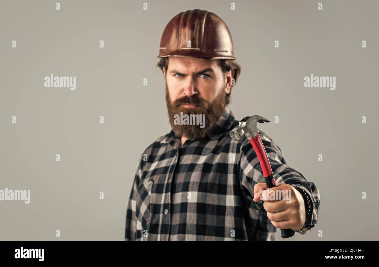 handsome bearded guy with beard and moustache hold hammer, selective ...