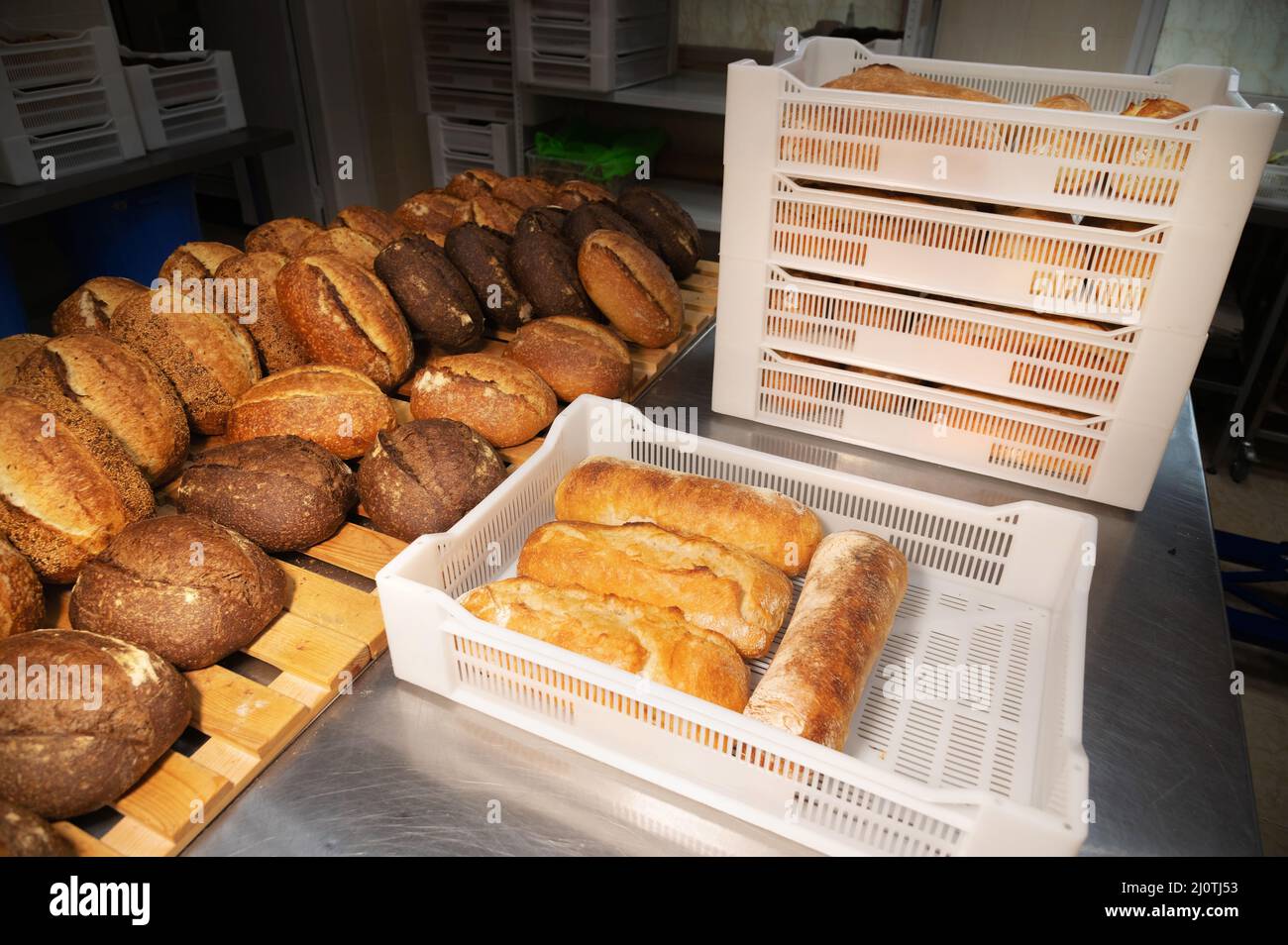 Fresh rolls of craft craft bread lies on the table in the bakery ...