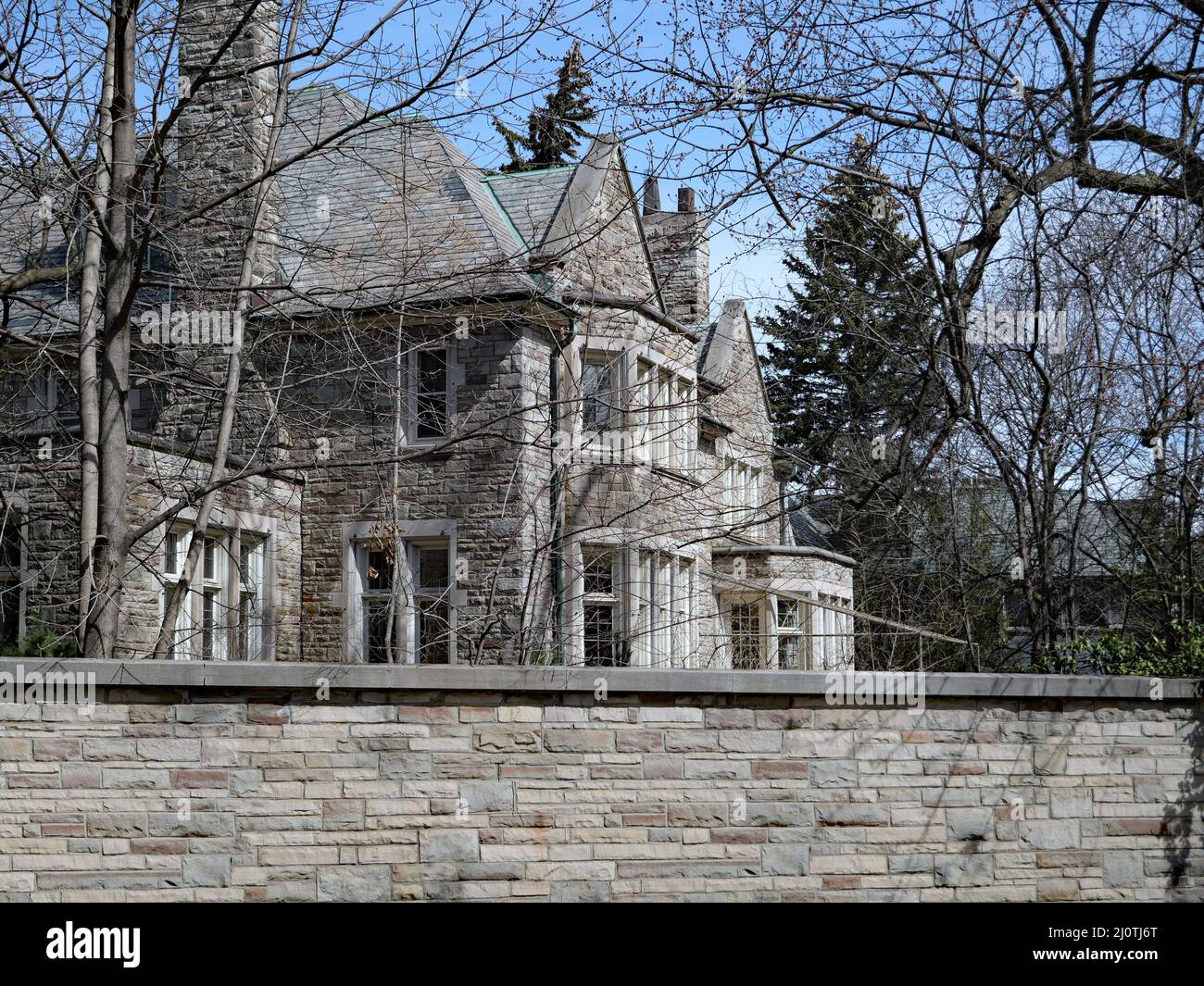 House protected by a high stone wall Stock Photo - Alamy