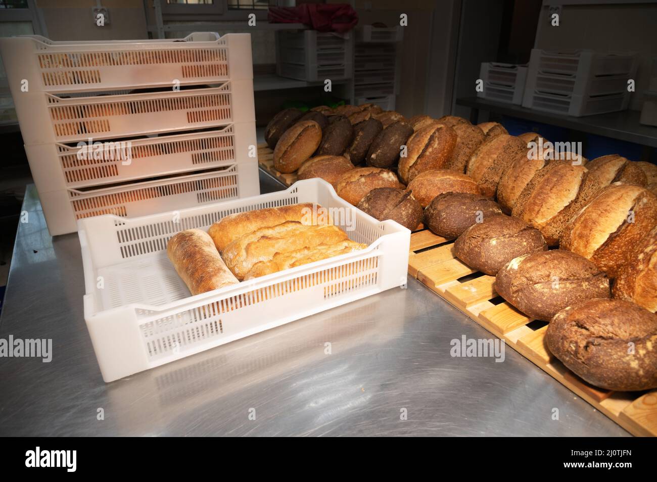 Fresh rolls of craft craft bread lies on the table in the bakery ...