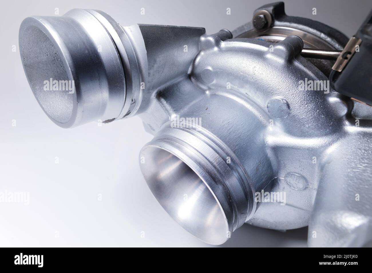 Auto parts new mechanical turbine made of metal on a gray background ...
