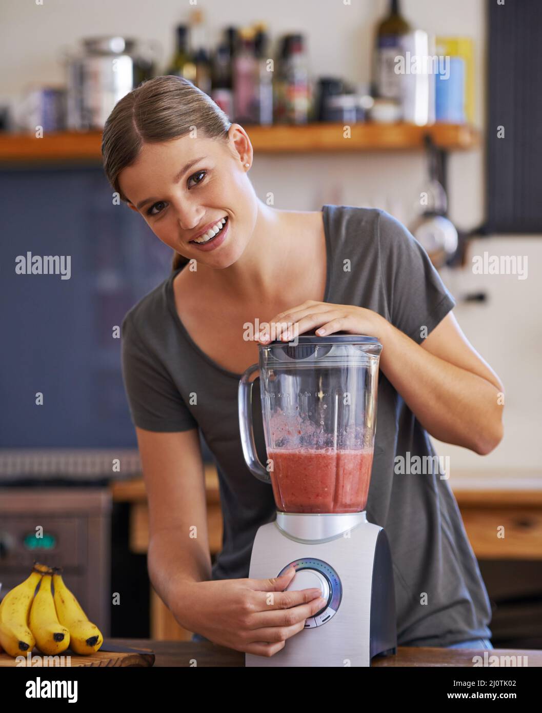 Making it oh so smooth. Portrait of an attractive young woman preparing ...