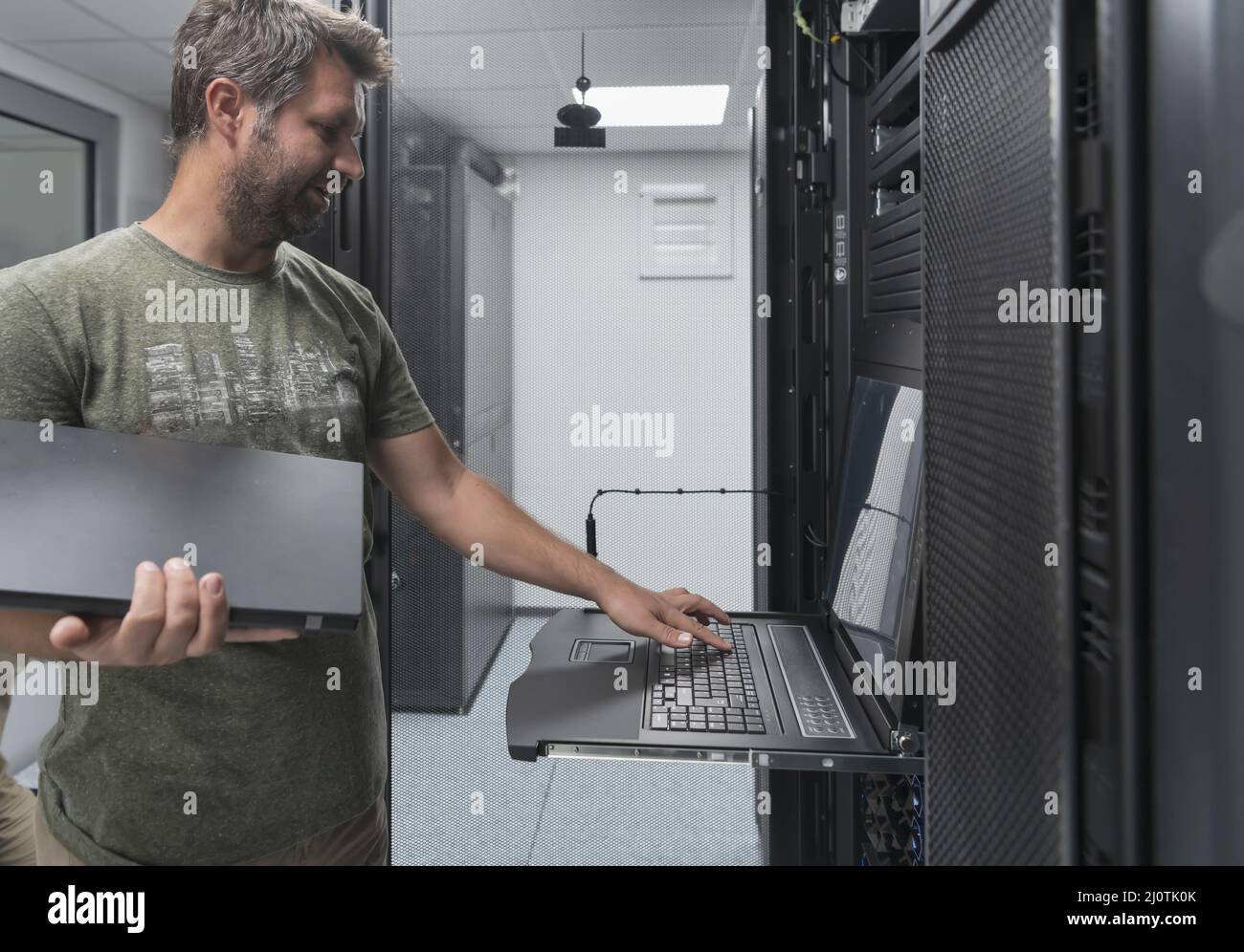 Close up on Data Center Engineer hands Using keyboard on a ...