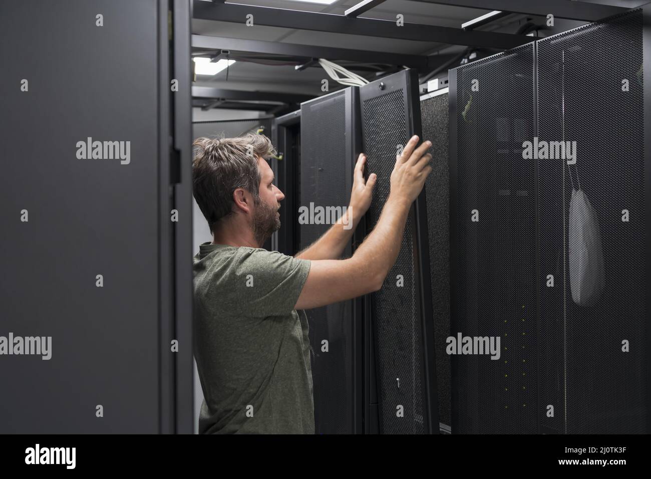 IT engineer working In the server room or data center The technician ...