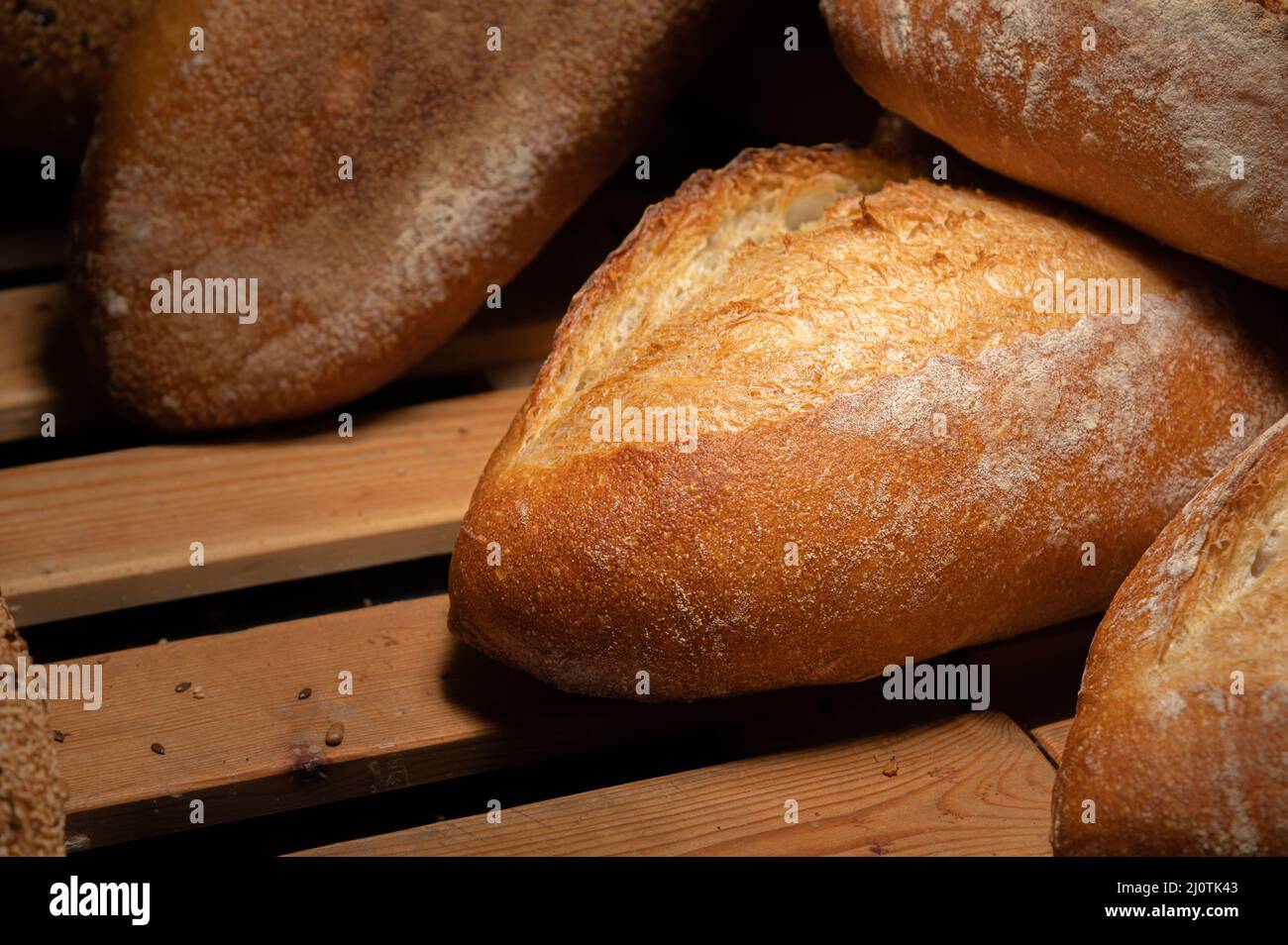 Craft loaves of bread. Fresh hot bread from the oven. Appetizing and ...