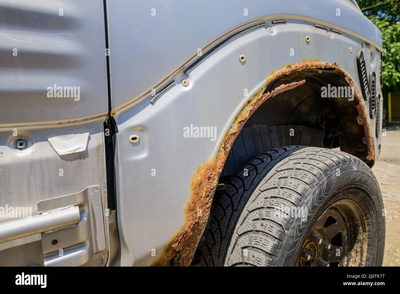 Rusty wheel arches on the car. car corrosion. Background for welding ...
