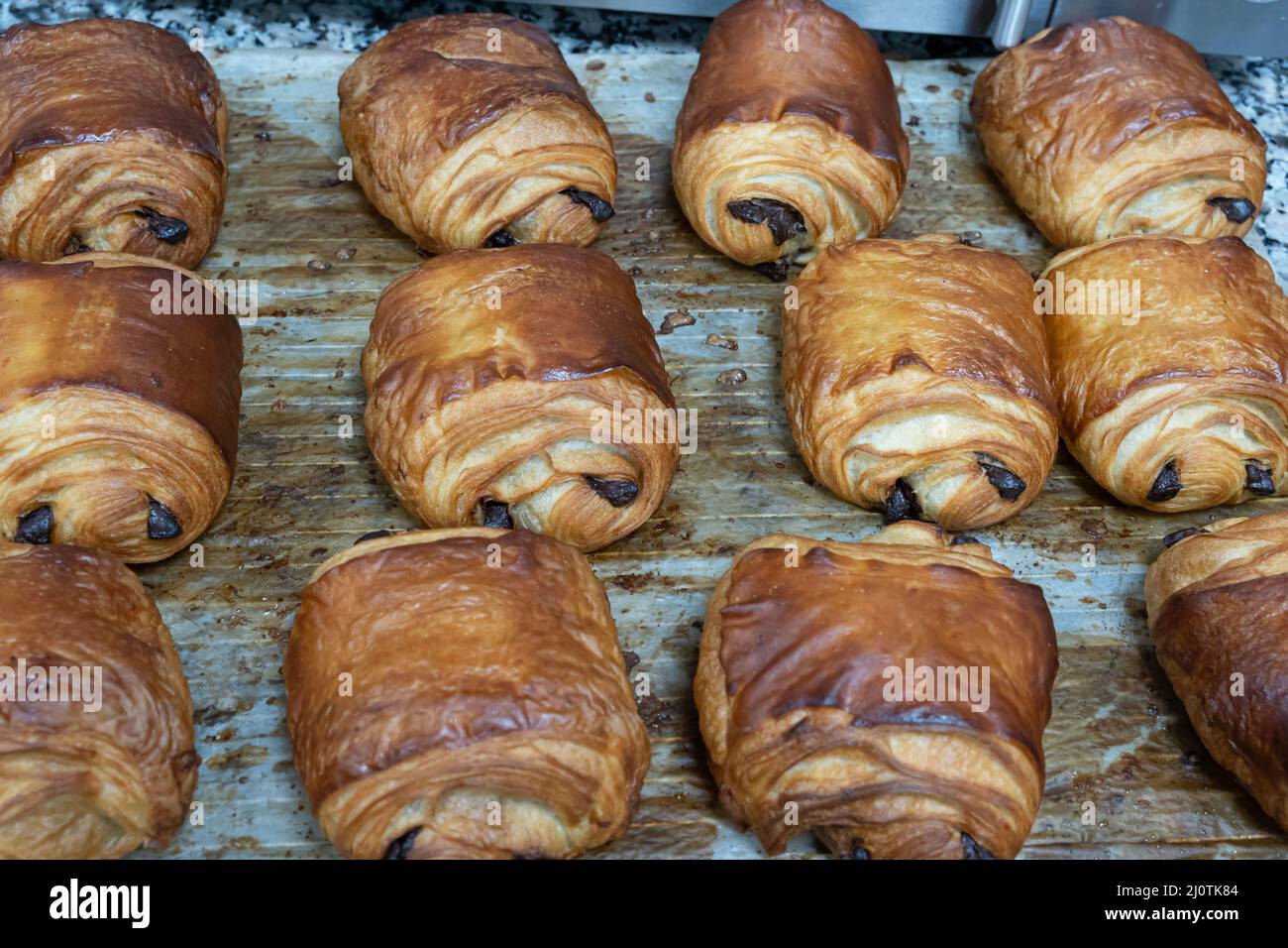 Artisan baker and pastry chef. Detail of chocolate bread pastries in a ...